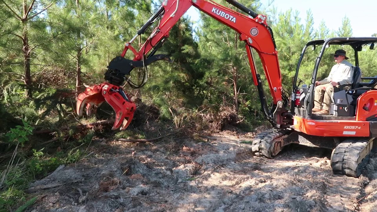 Cleaning brush debris with the mini excavator - YouTube