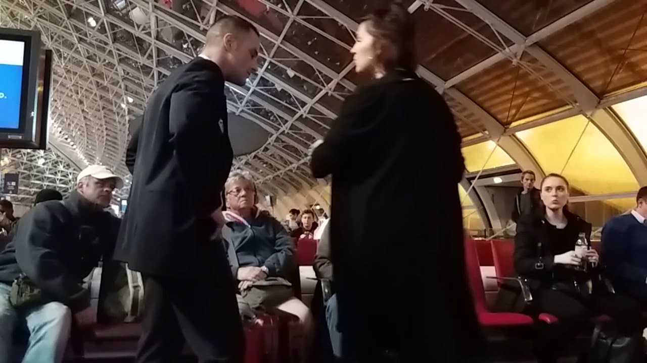 German tourists peevishly refusing to check their carry-on baggage when ...