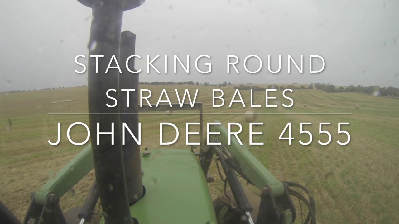 Stacking round straw bales. - YouTube