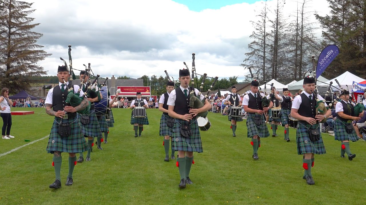 Pipe Major James Cooper leads Ballater Pipe Band for competition during ...
