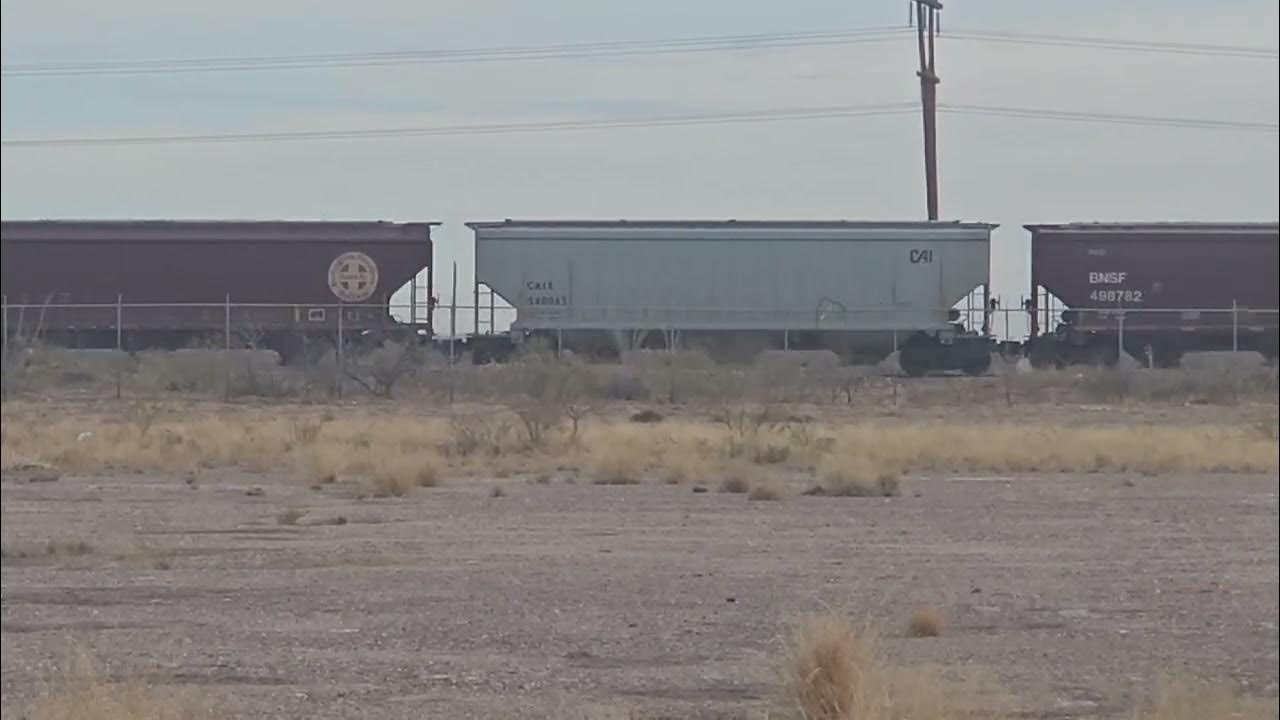 BNSF single engine leads a eastbound grain train with a rear DPU on the GSR in Northeast El Paso ...