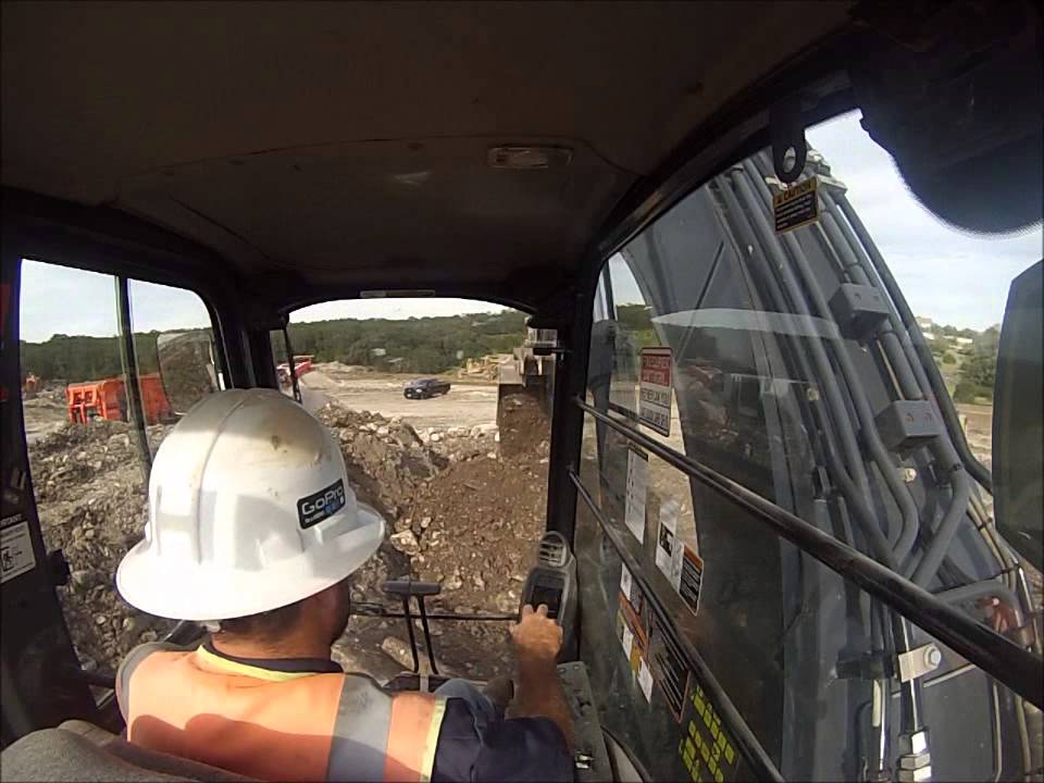 210G excavator stockpiling material - YouTube