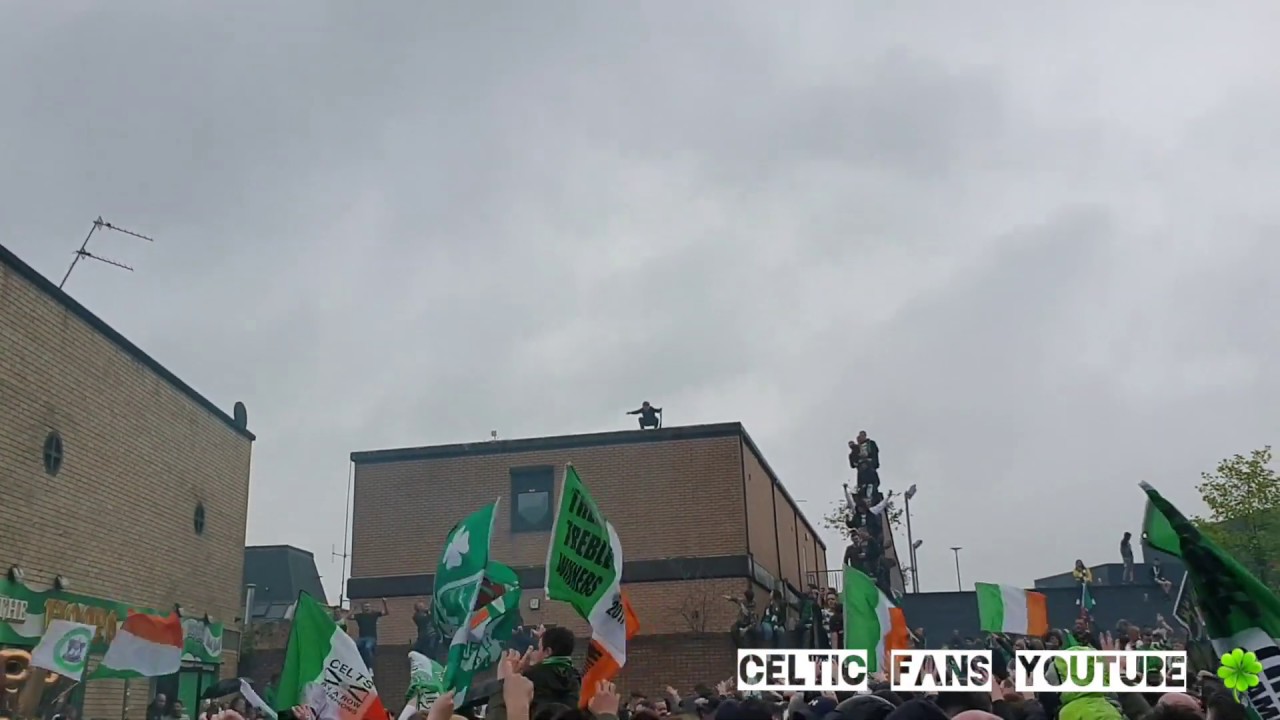 Celtic Fan on roof leads fans in the Gallowgate - YouTube