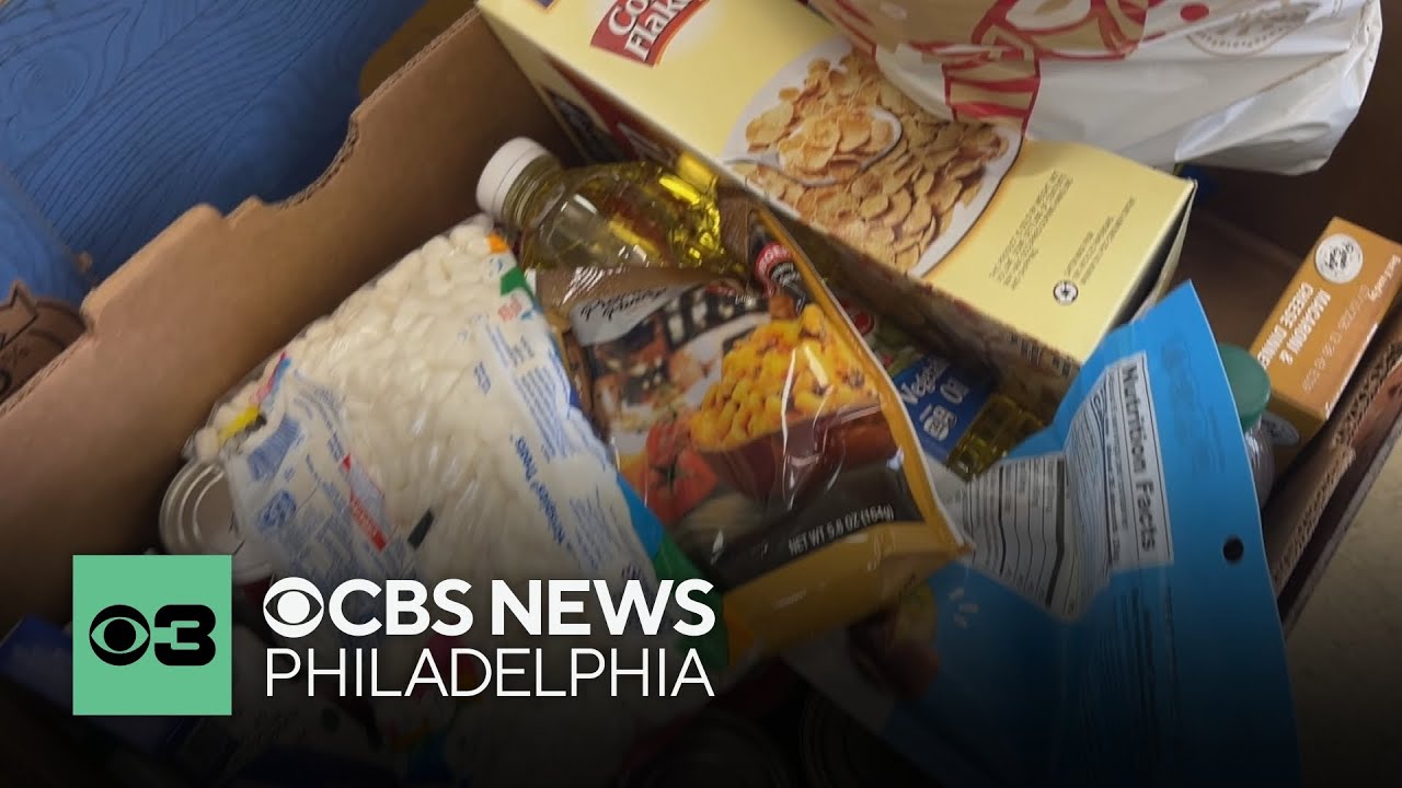 Volunteers fill boxes at the Food Bank of South Jersey as federal ...