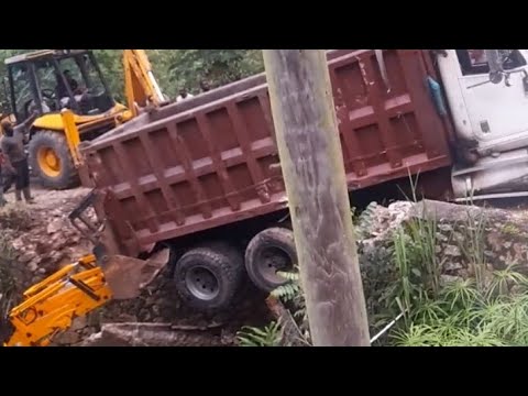 Two backhoe and another truck recovering a Dump truck from the ditch - YouTube