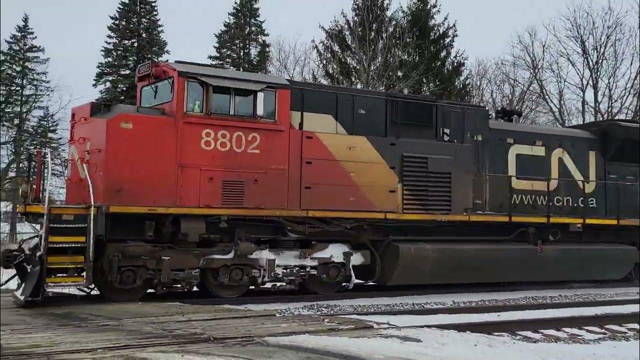CN 8802, 2269 haul a Westbound train with IC coil car, UP, HURON & EASTERN hoppers at Vicksburg ...