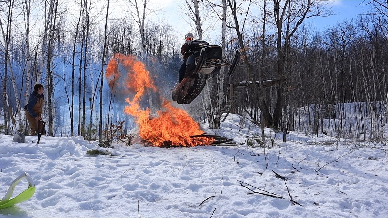 Snowmobile jumps through fire! (Crashed) - YouTube