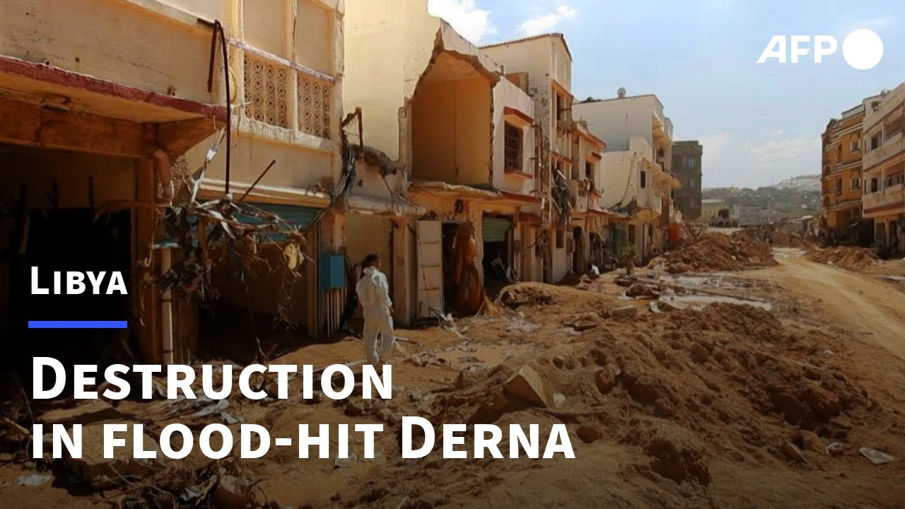 People walk amid rubble in Libya's flood-hit Derna | AFP - YouTube