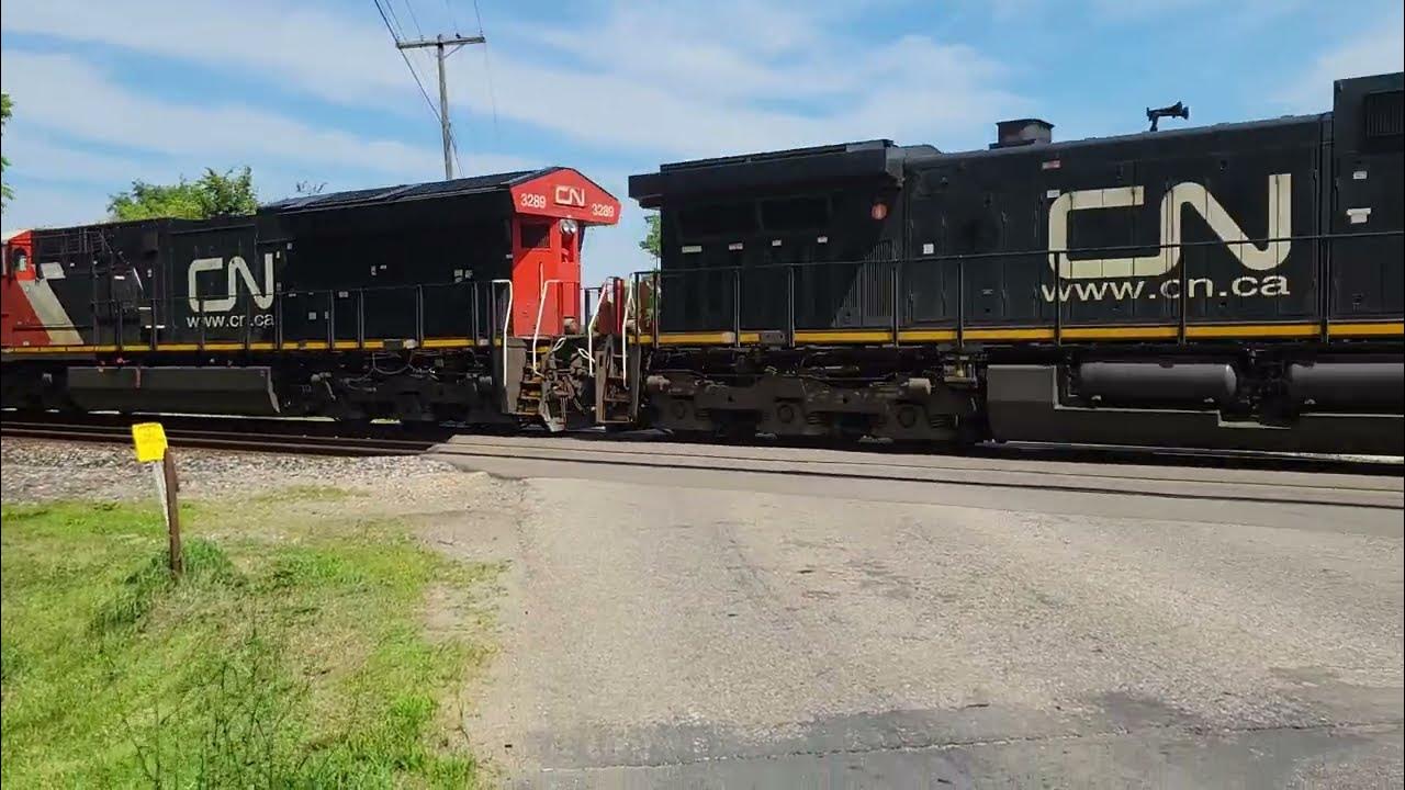 CN 3289, 3308 move Eastbound freight train with CN Trinity 3-bay covered hoppers at Vicksburg ...