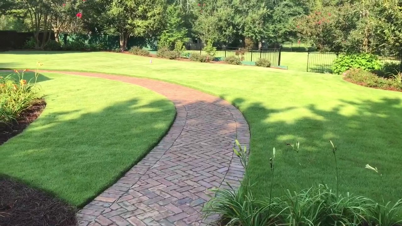 Tumbled brick paver in a unique landscape design - YouTube