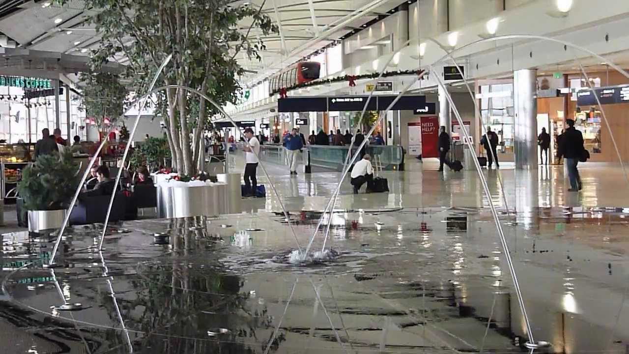 Red train and water fountain in Detroit airport terminal - YouTube