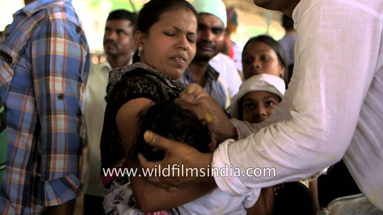 A child gets 'Bathini fish medicine' - Hyderabad - YouTube