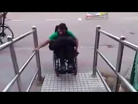 Pushing wheelchair up the ramp while carrying luggage. - YouTube