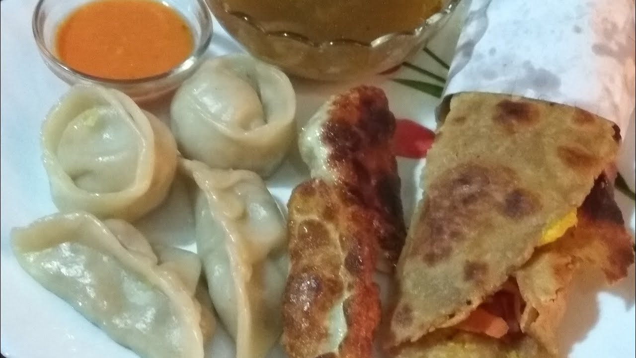 Eating homemade steamed momos , fried momos with hot sauce and egg roll ...