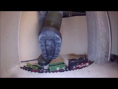 Stomping a train toy under many rubber boots - YouTube