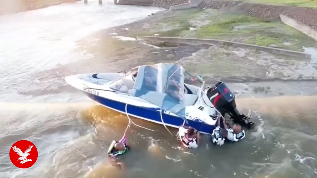 Dramatic moment boaters on dam rescued from edge of 130ft drop - YouTube