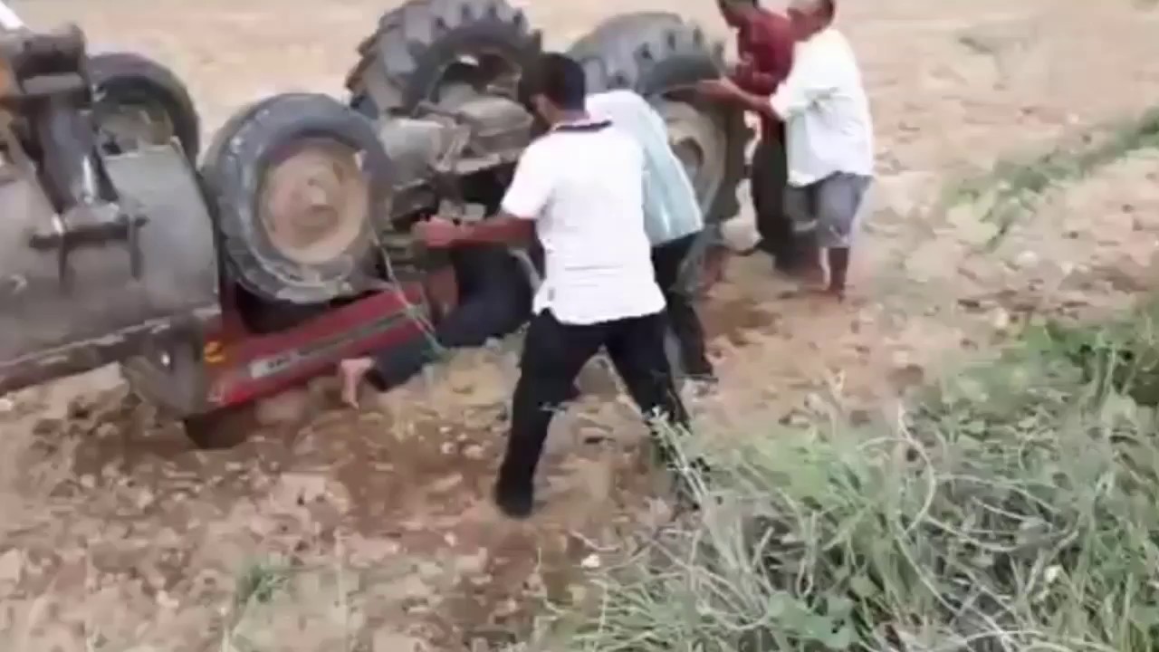 Man being crushed by tractor walks away unharmed - YouTube