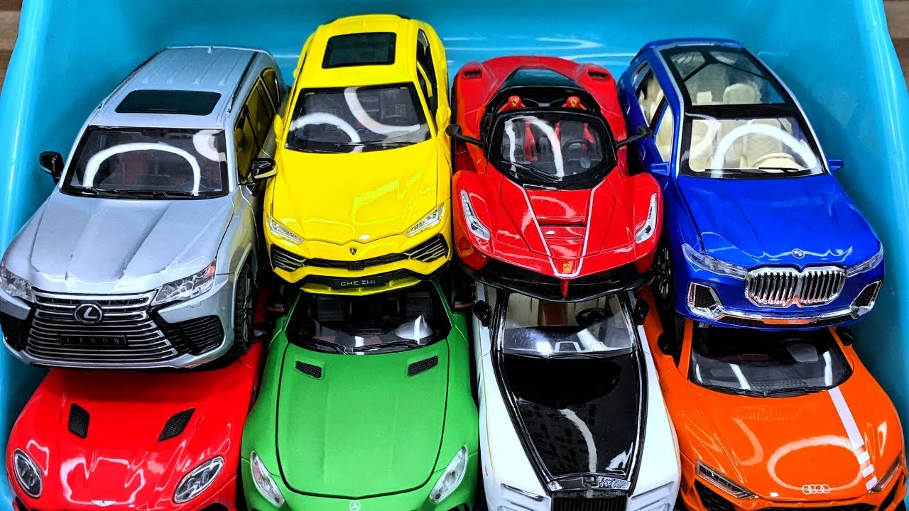 Box full of various miniature cars Jaguar, Peugeot, Renault, Hyundai ...