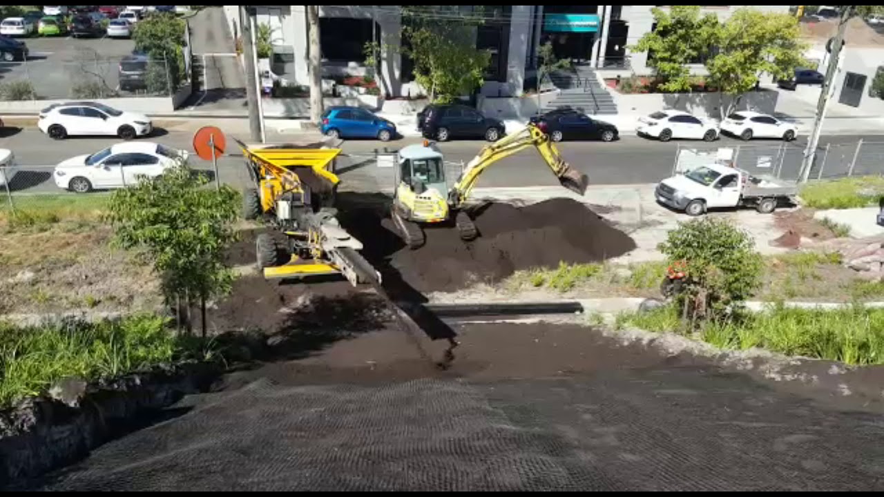 Stone slinger / Rock slinger topsoils a steep batter by Metropolis ...