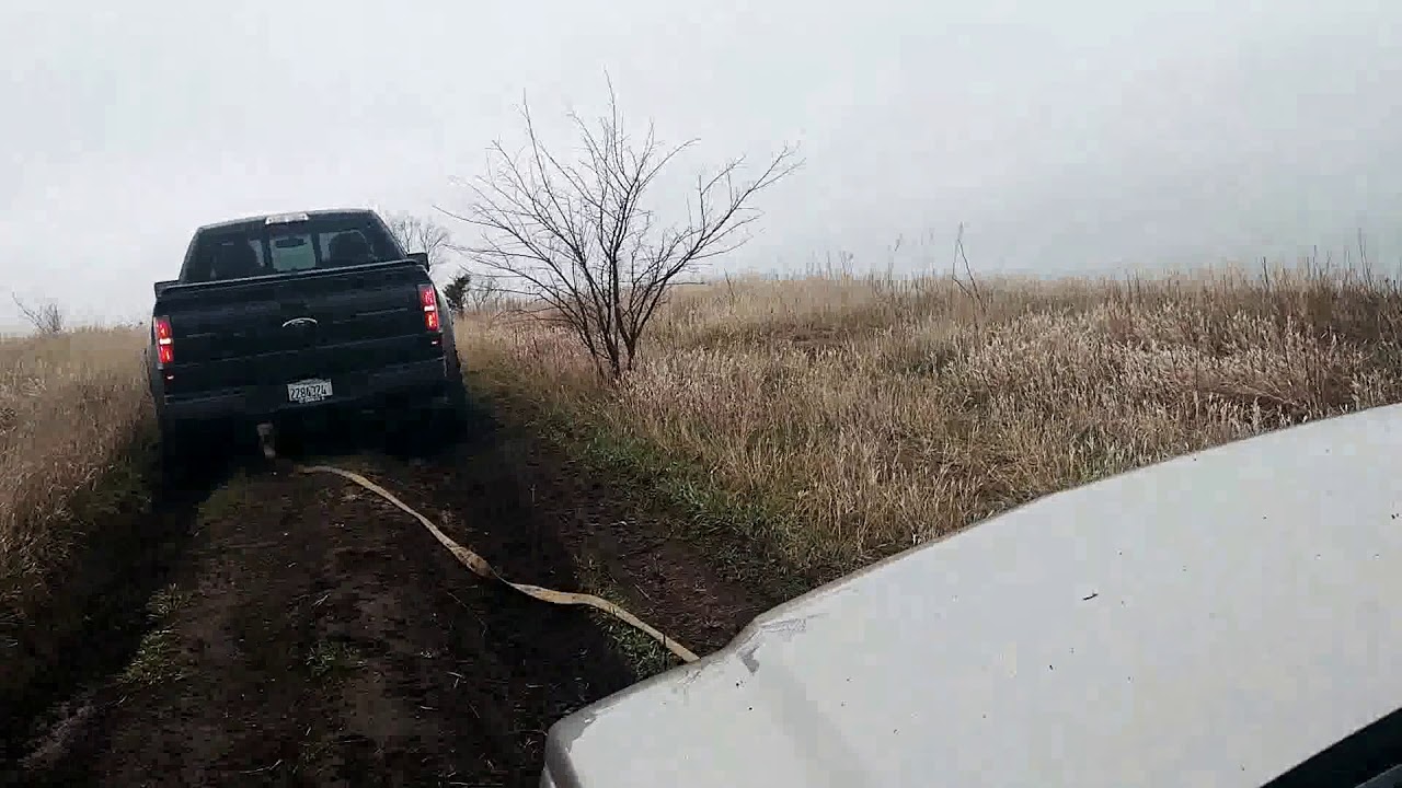 Ford raptor pulling out a Silverado stuck in a hill - YouTube