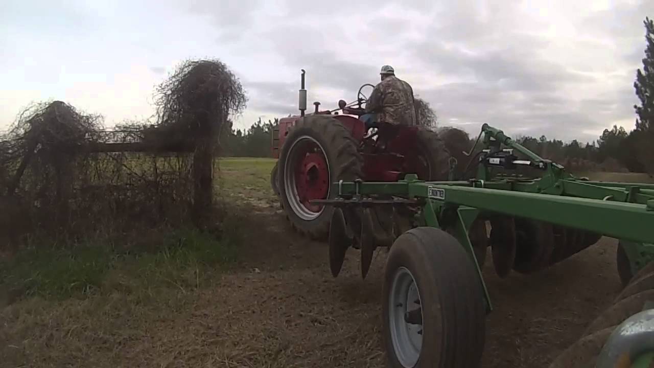 1949 Farmall M pulling a 9.5 foot disk - YouTube