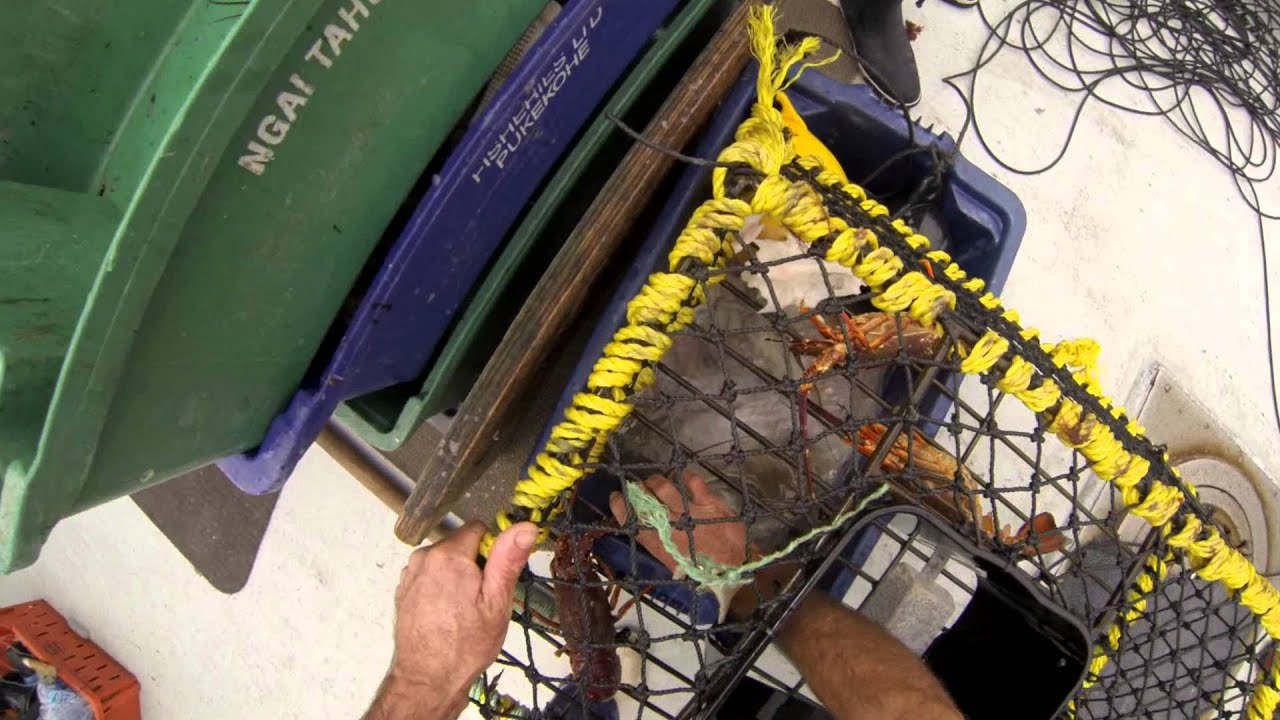 Lifting a Cray pot onto a boat - YouTube