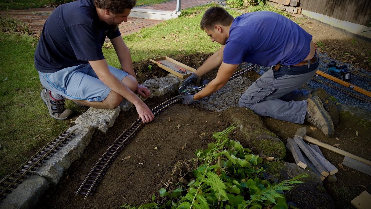 LGB layout expansion, installing more TRACK and RAILROAD CROSSING - YouTube