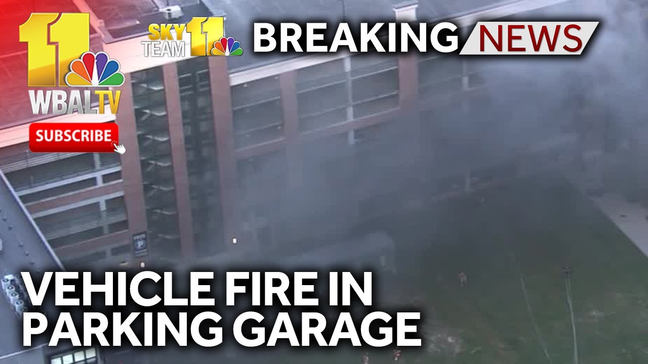 Crews extinguish vehicle fire in parking garage - YouTube