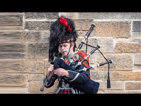 A Scottish Piper Man in Kilt Playing Bagpipes Busking in London Big Ben ...