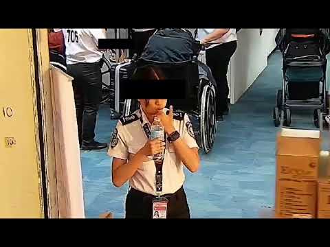 A female security screening officer at NAIA swallowing US$300 dollar bills she had stolen from pax