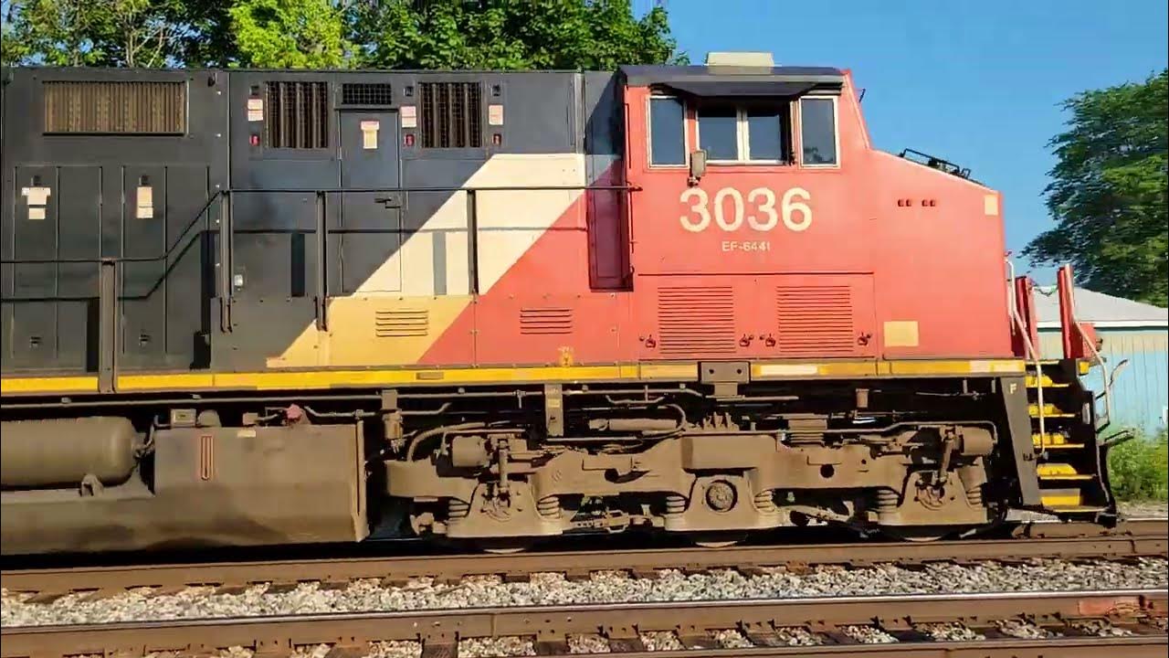 CN 3036, 3005 roll Westbound freight train with BN, BNSF hoppers, well cars past Vicksburg, MI ...
