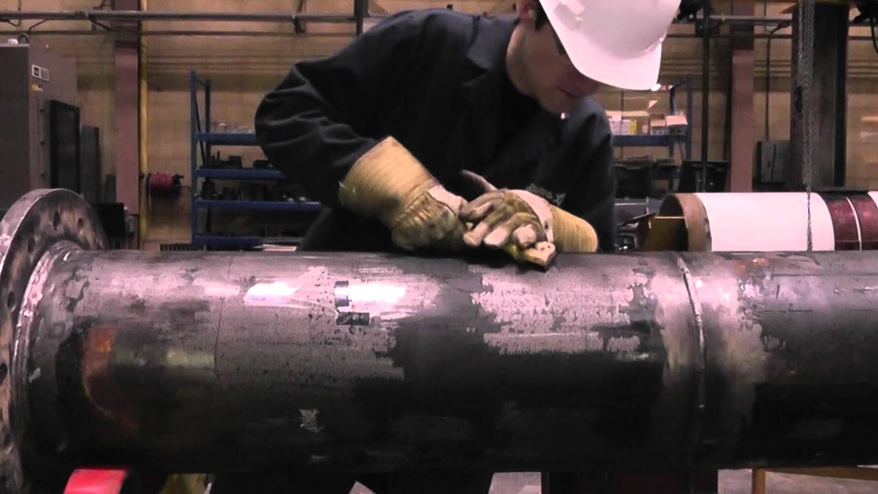 Scraping the pipe before the installation of strain gauges - YouTube