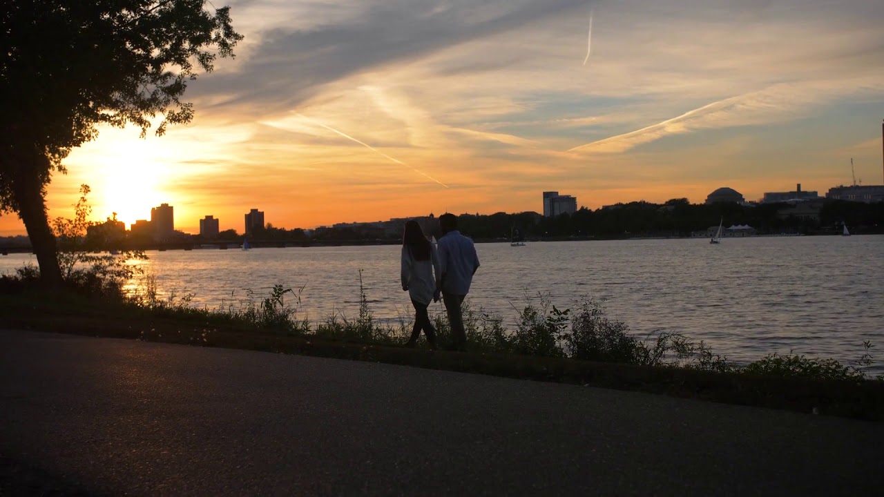 couple walk together at sunset boston park skyline over water - YouTube