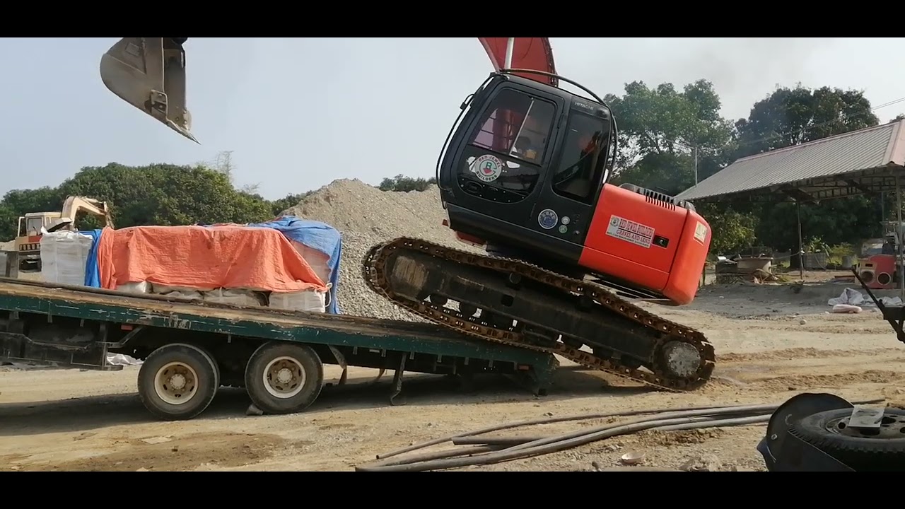 how to load excavator from a self loading truck? - YouTube