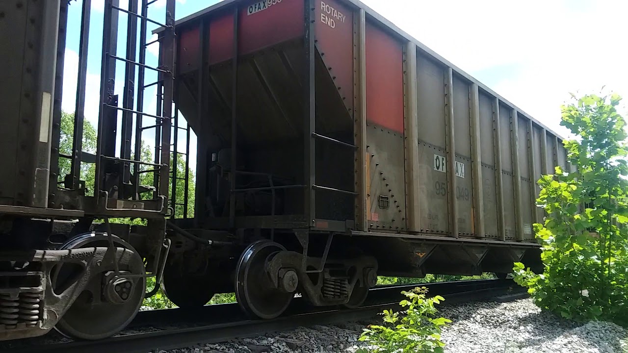 EMD SD 38-2 with empty hopper cars going thru a slow order work zone ...