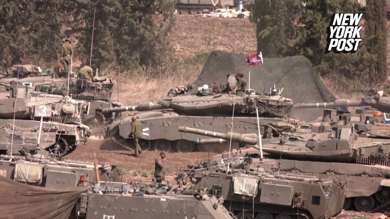 Israeli military tanks seen massing by the Israel-Lebanon border - YouTube