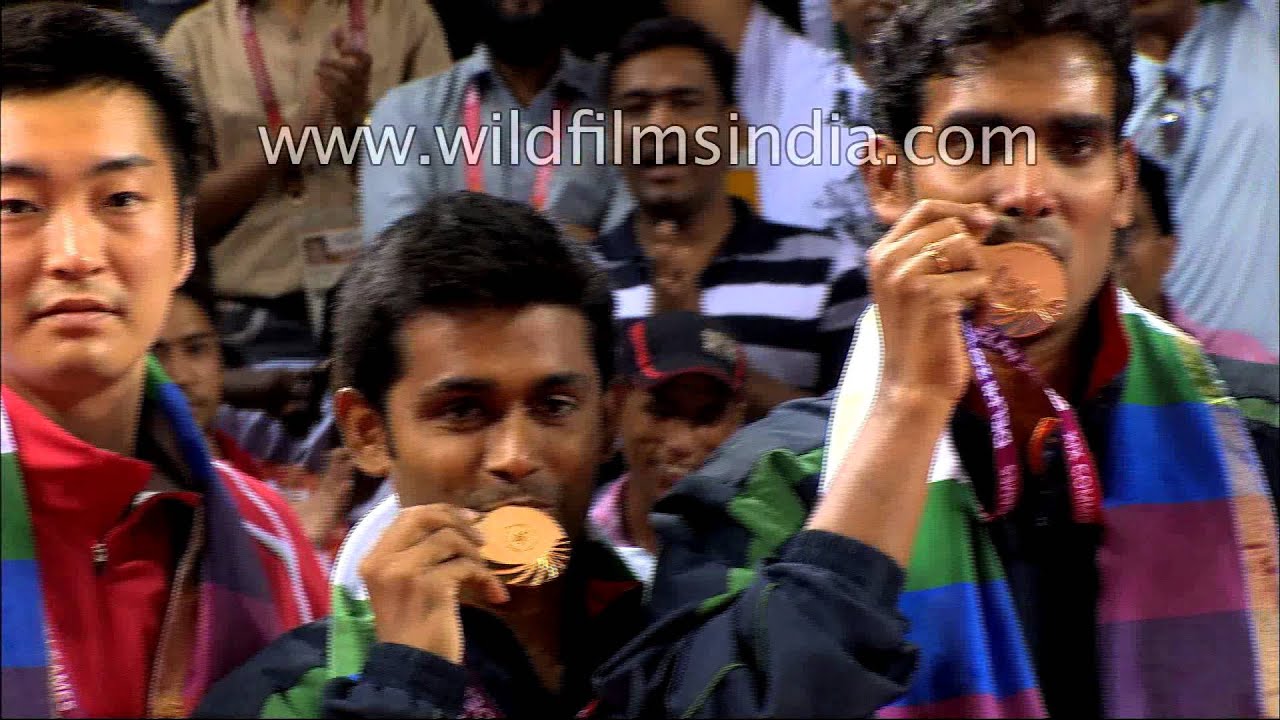 Why do Gold medal winners bite their medals? - YouTube