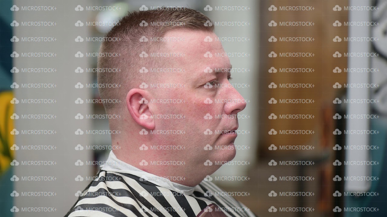 Men's haircut in Barbershop. Close-up of master clipping a man's brow ...