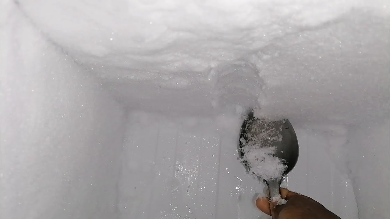 build up freezer frost scraping with a steel spoon - YouTube
