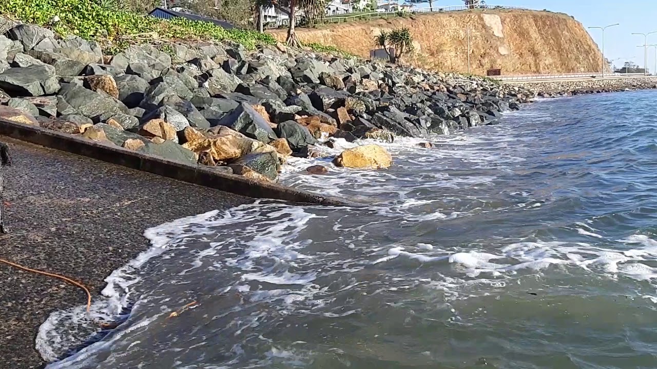 Microplastic marine debris come out of rock wall on high tide - YouTube