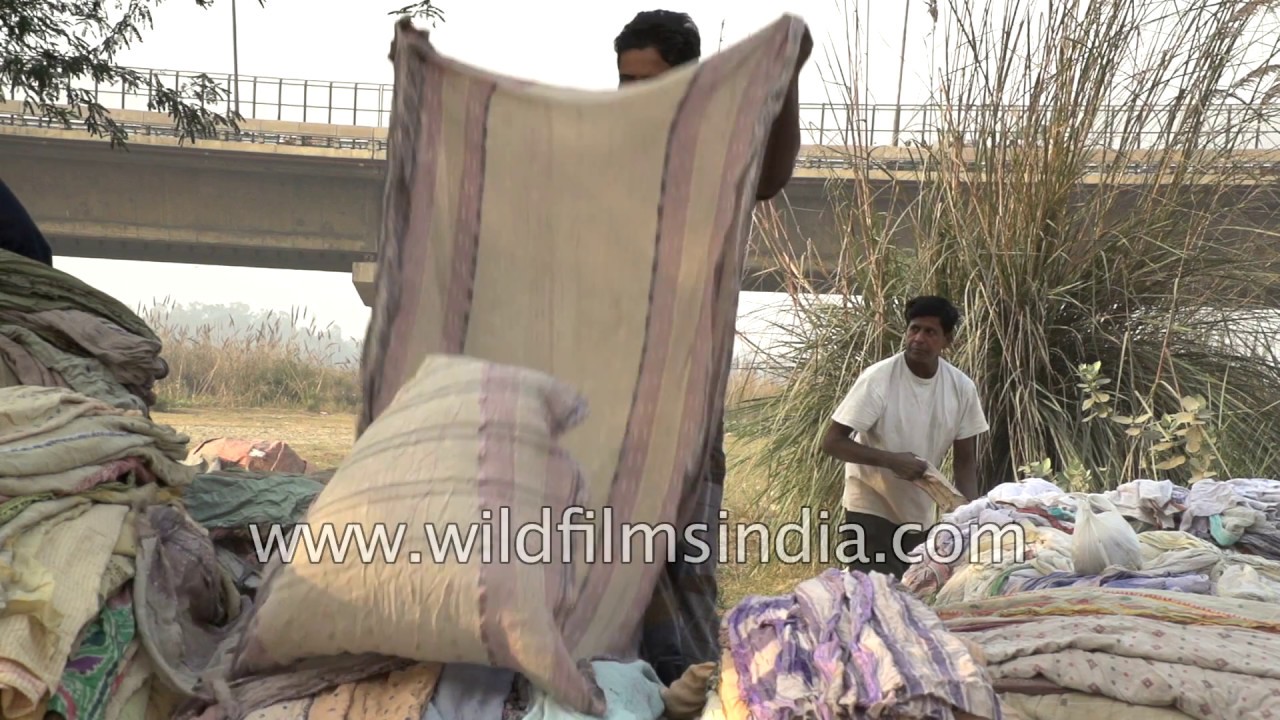 Indian washerman at work on a bank of river Yamuna, Delhi - YouTube