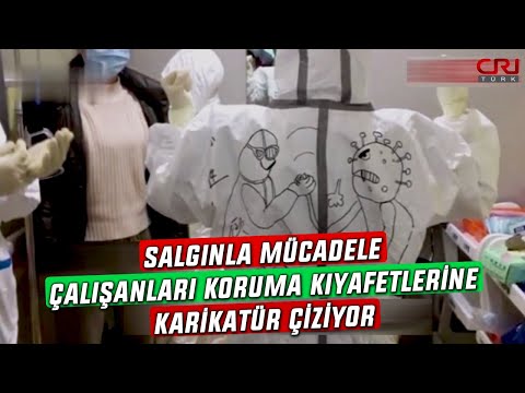 Salgınla mücadele çalışanları koruma kıyafetlerine karikatür çiziyor