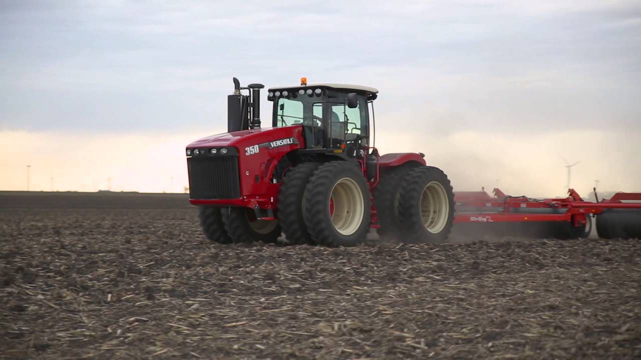 Versatile 4WD model 350 pulling a 60' Rite Way roller - YouTube