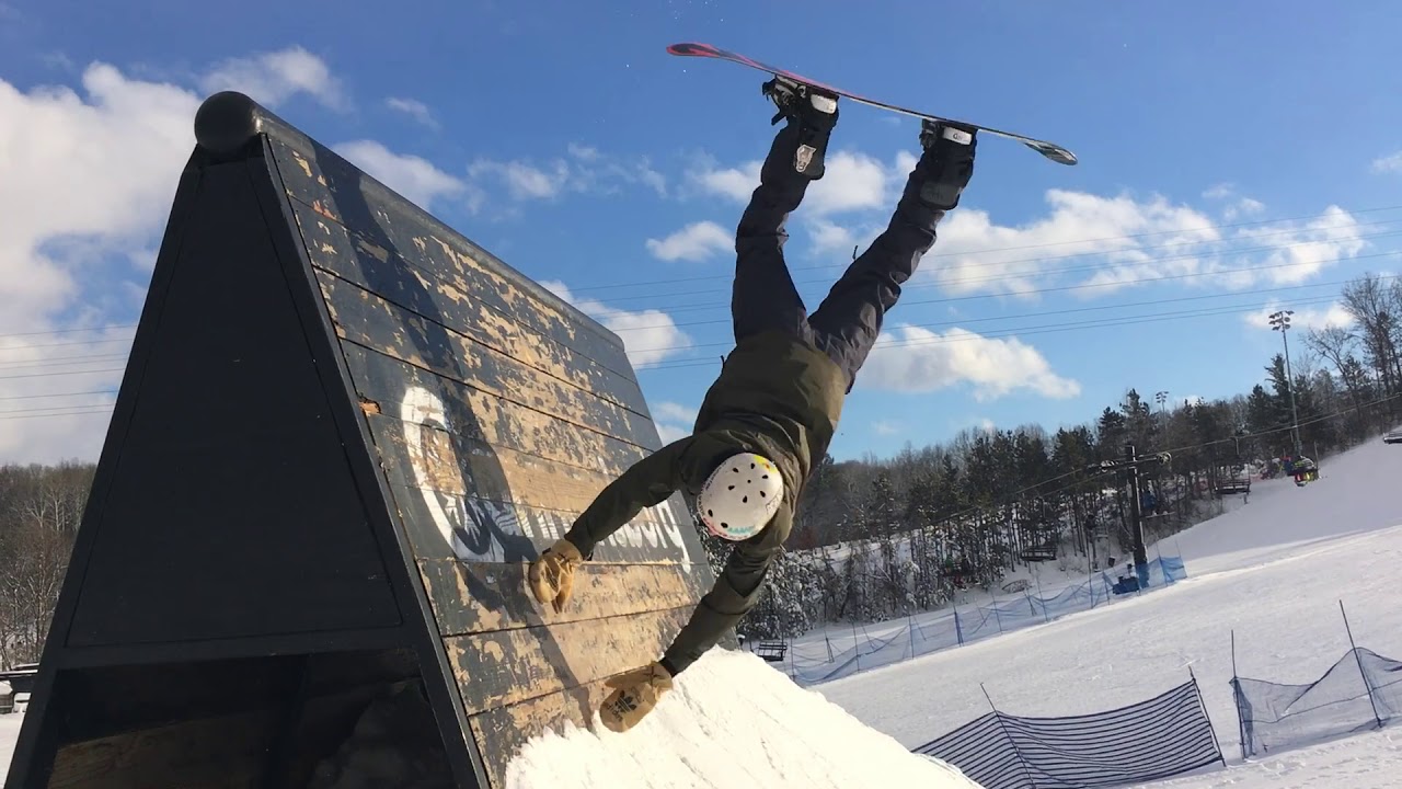 Snowboarders do tricks on freestyle park features at Cannonsburg Ski ...