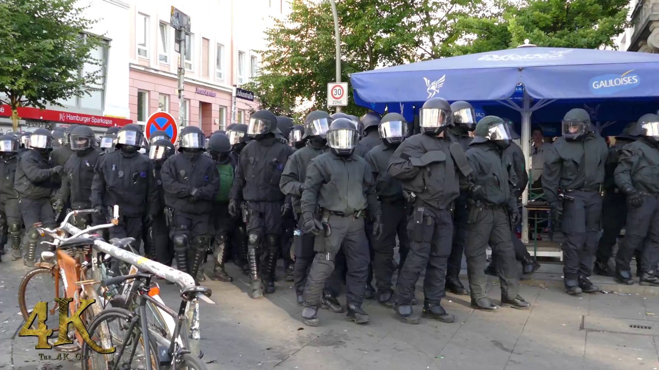 Riot police moving away while protesters chant ''Who's streets, our ...