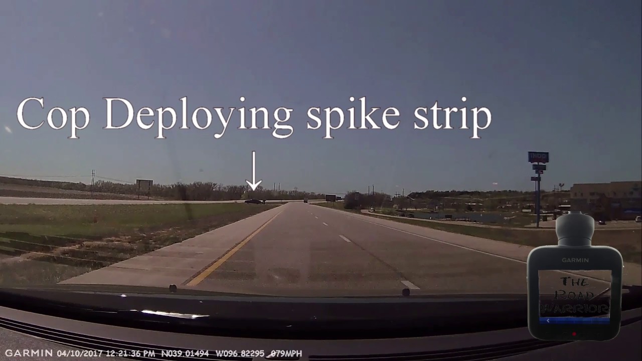 Highway patrol on I-70 deploying a spike strip - YouTube