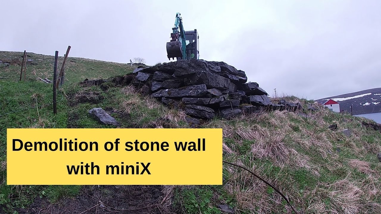 Demolition of stone wall with mini excavator - YouTube