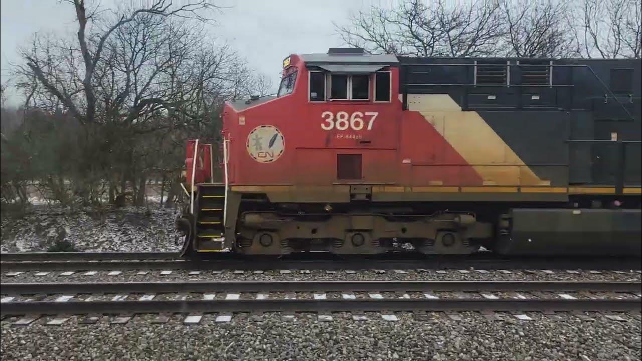 CN 3867, 3180 speed an Eastbound train potash covered hoppers, auto ...