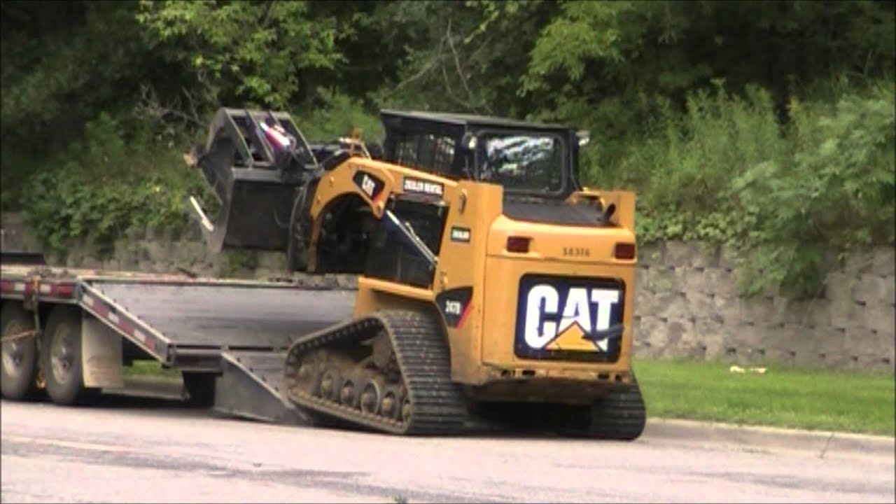 Cat 247B Unloading From Trailer - YouTube