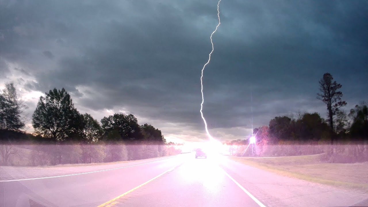 An intense lightning bolt strikes nearby, sending sparks flying from a ...